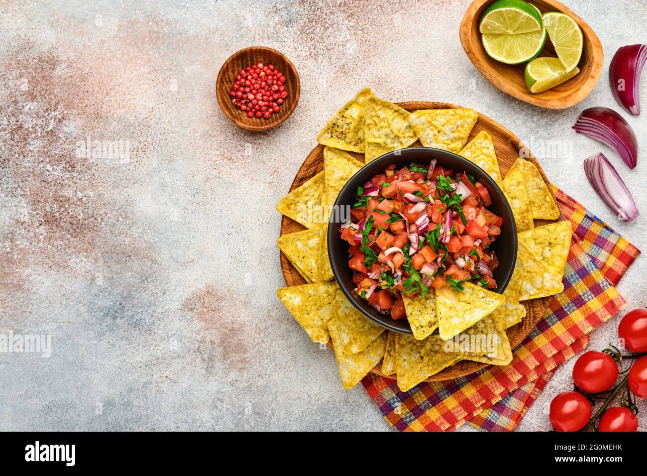 Traditional Mexican tomato sauce salsa with nachos and ingredients ...