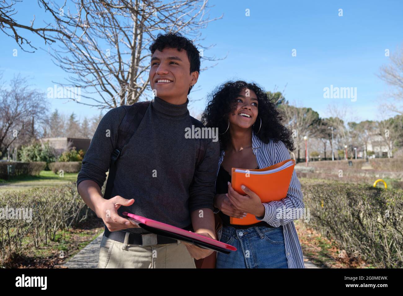 Two latin students smiling at the college campus. University life Stock ...