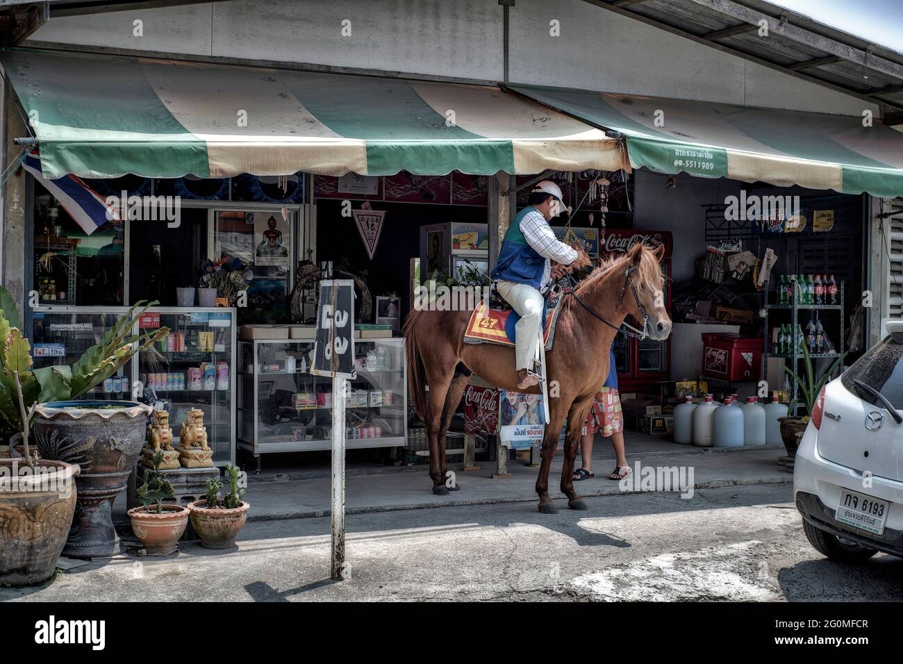 Horse and rider shopping at street store. Thailand Southeast Asia Stock ...