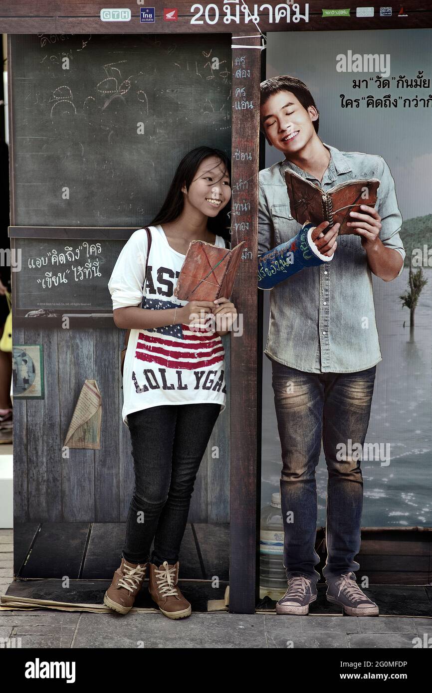 Posing with statue. Teen girl posing with statue of handsome young man ...