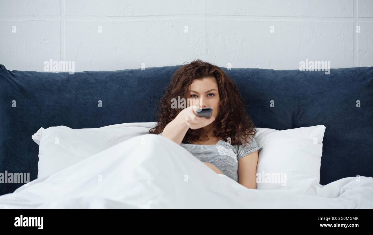 Woman remote controller in hi-res stock photography and images - Alamy