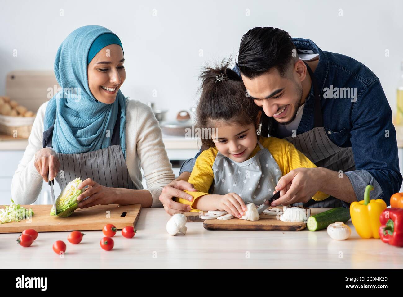 Loving Muslim Parents Teaching Their Little Daughter How To Cook ...