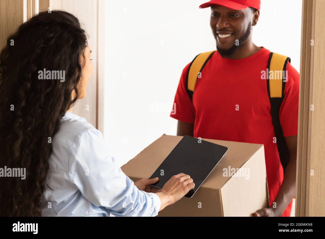 Female Customer Receiving Order Signing Digital Form Stock Photo - Alamy