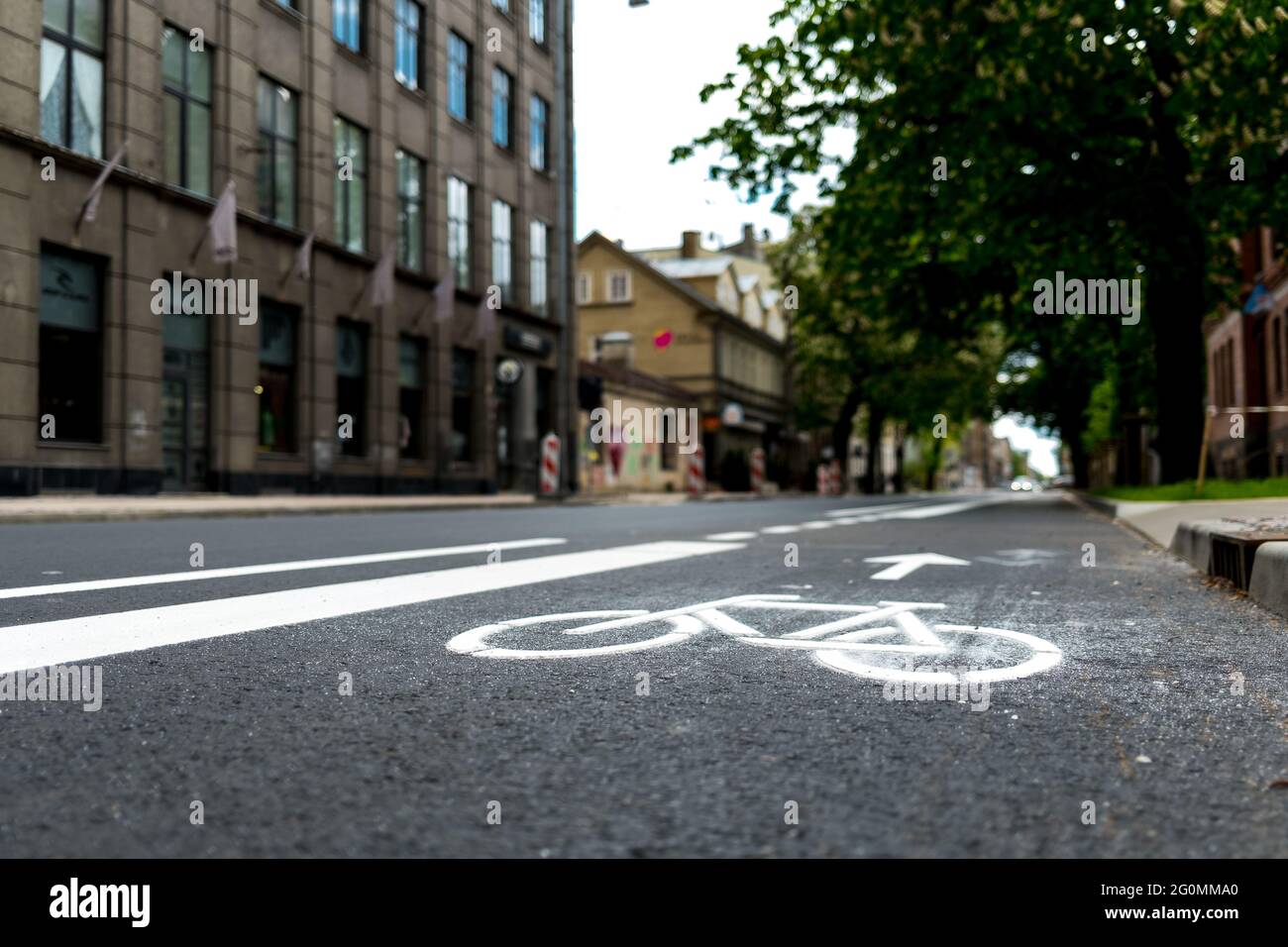Selective focus of a freshly build bicycle lane in the city with sign ...