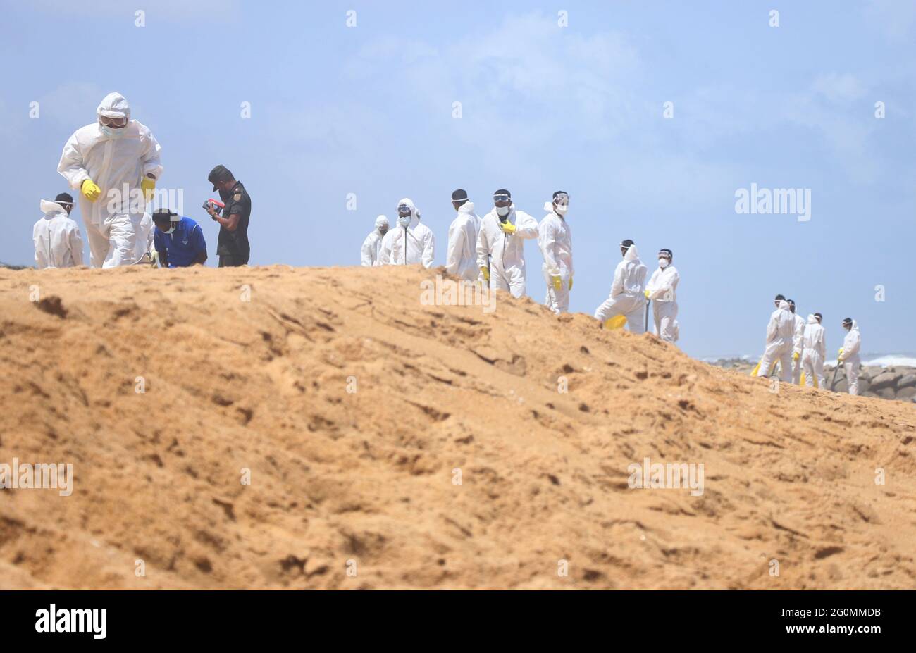 (6/1/2021) Sri Lanka Army personnel remove debris on the beach at ...