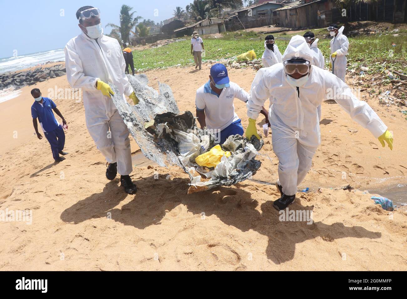 (6/1/2021) Sri Lanka Army personnel remove debris on the beach at ...