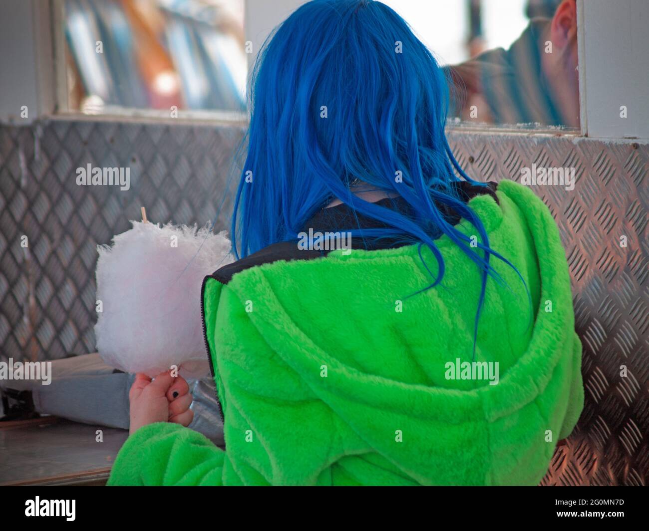 A blue haired girl eats candy floss on the pier at Brighton Stock Photo ...