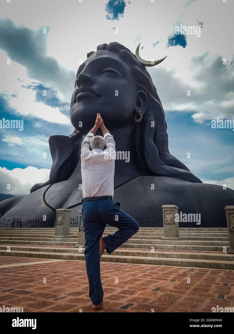 Devotee paying salutaion to the adiyogi shiva in yog asnam image is ...