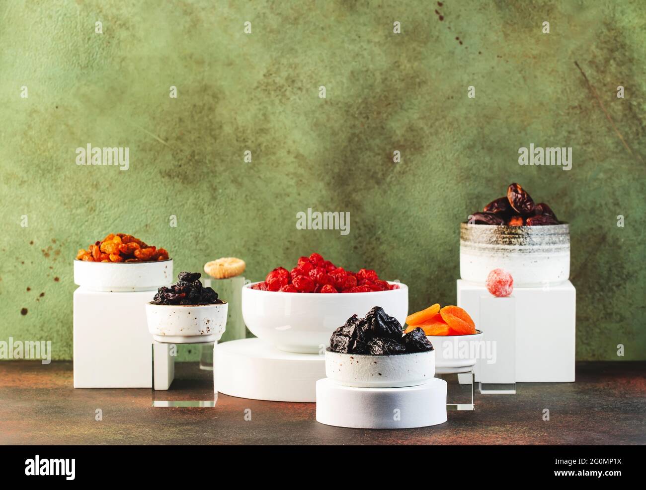 Healthy food snacks: natural dried fruits in bowls on rusty green ...