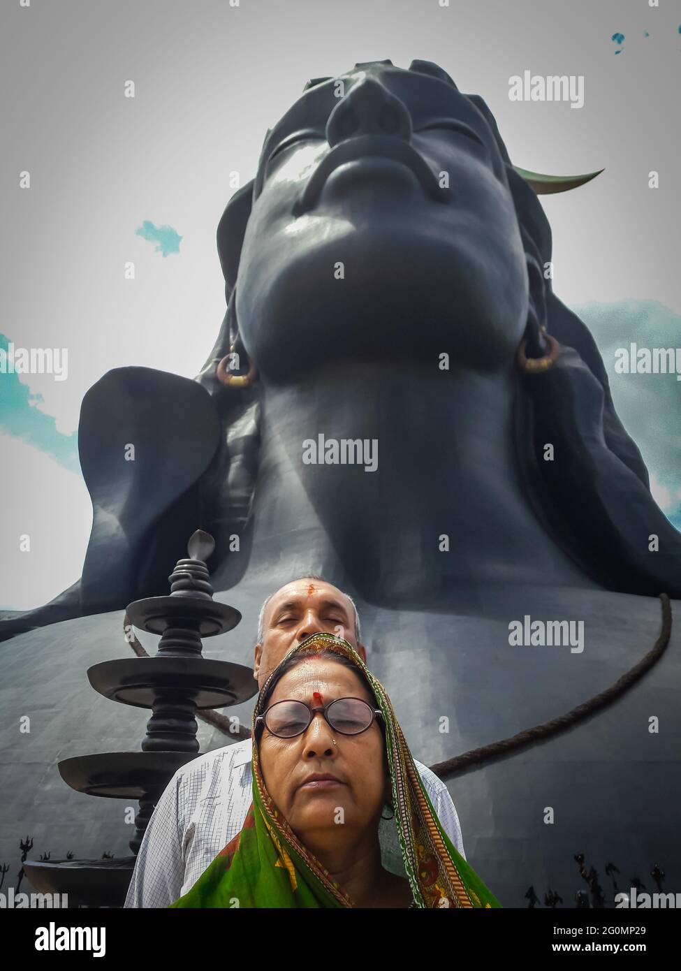 Devotee paying salutaion to the adiyogi shiva in yog asnam image is ...