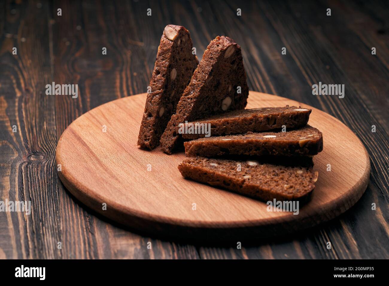 slices of rye bread with pine nuts on a wooden board Stock Photo - Alamy
