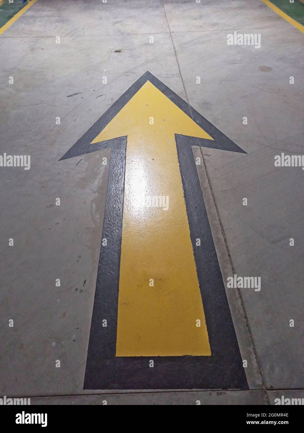 An Arrow showing direction on the floor Stock Photo - Alamy