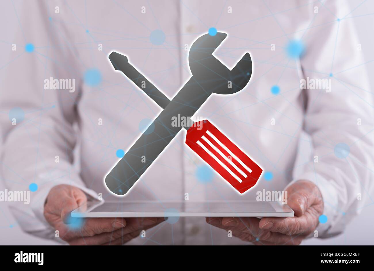 Maintenance service concept above a tablet held by a man in background ...