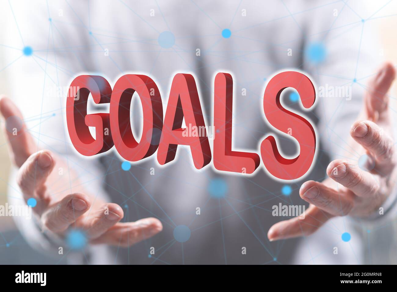 Goals concept above the hands of a man in background Stock Photo - Alamy