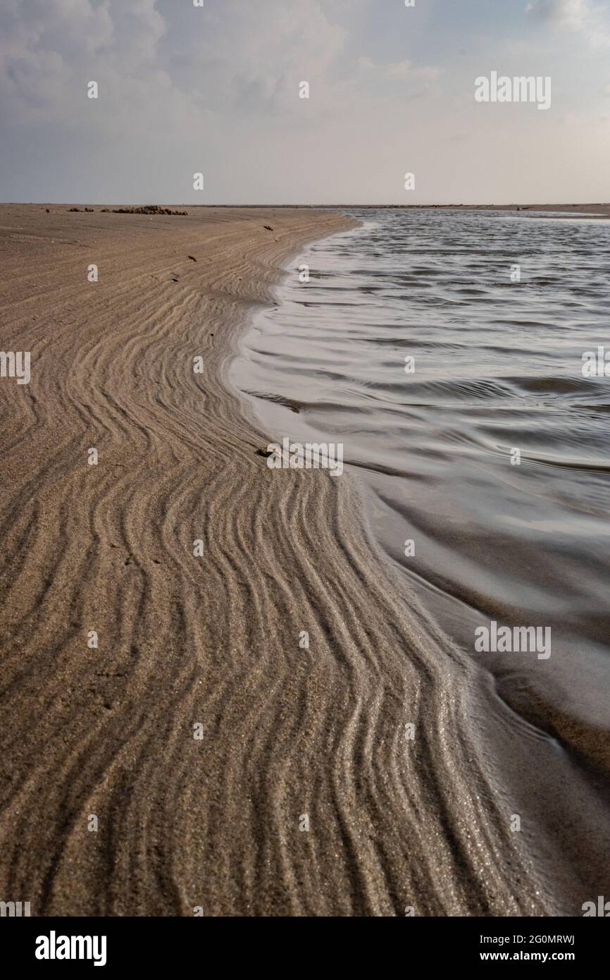 natural pattern made by sea waves on sandy beach is showing the act of ...
