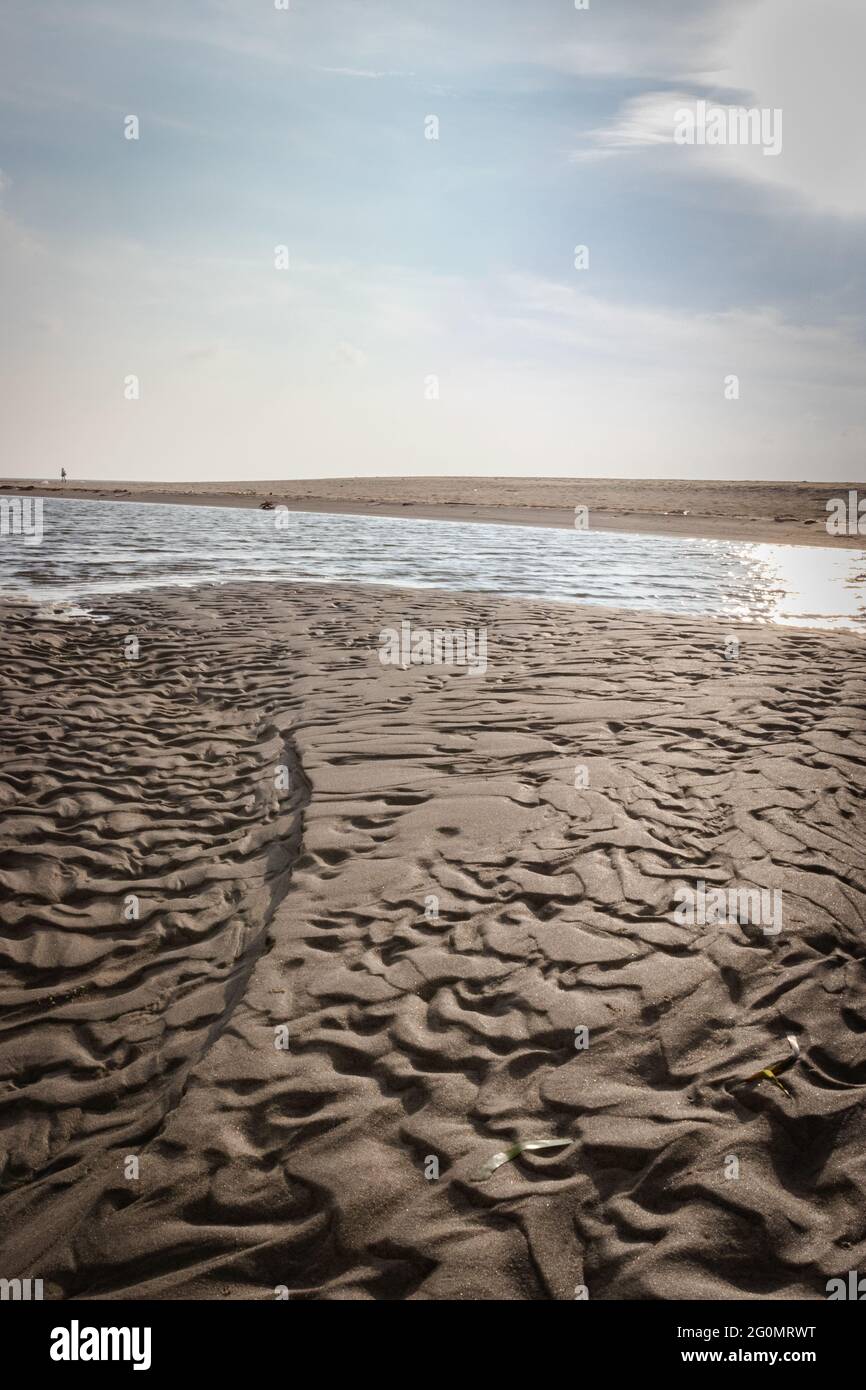 natural pattern made by sea waves on sandy beach is showing the act of ...