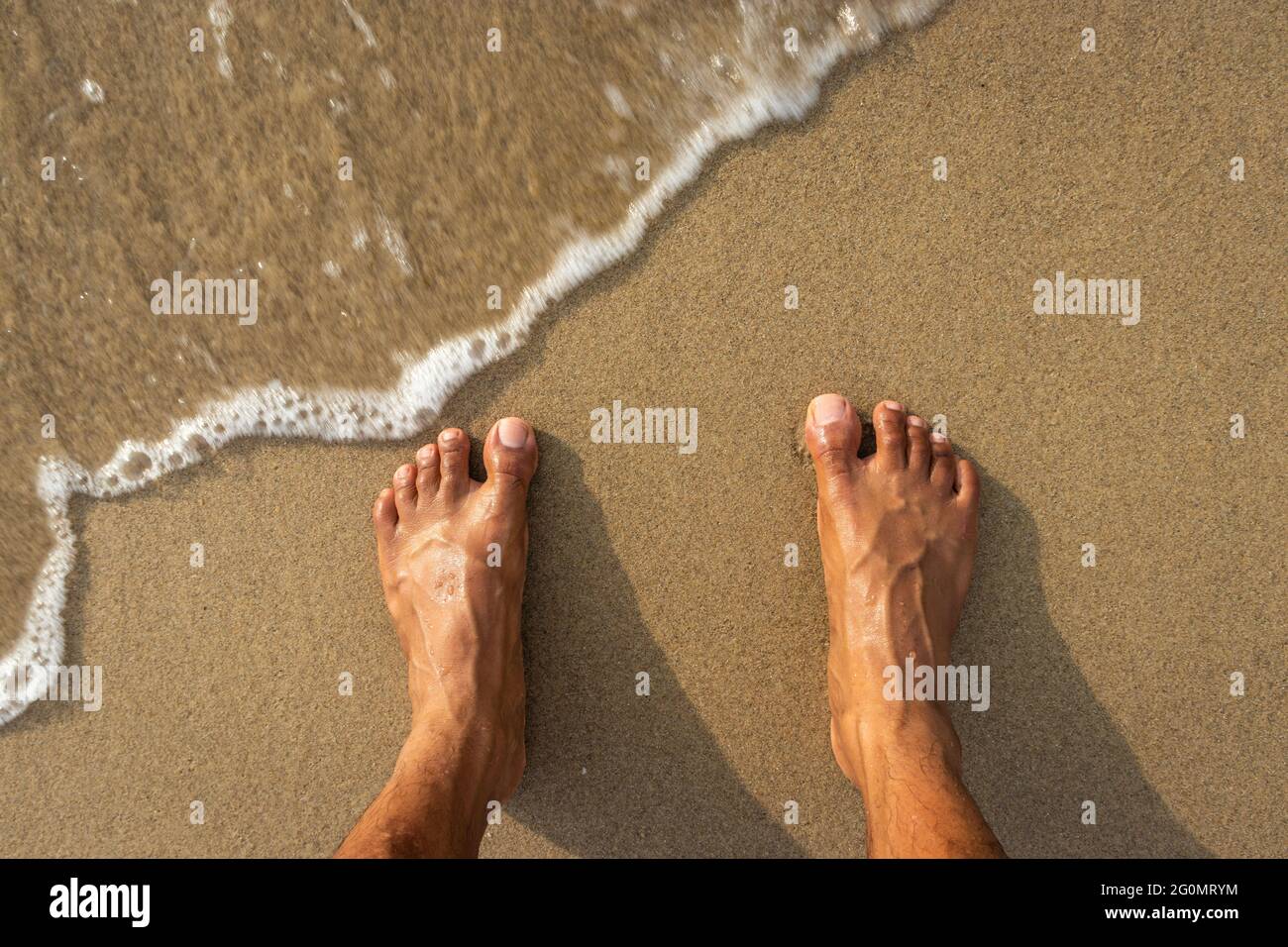 human feet feeling nature isolated on sandy beach showing the human ...