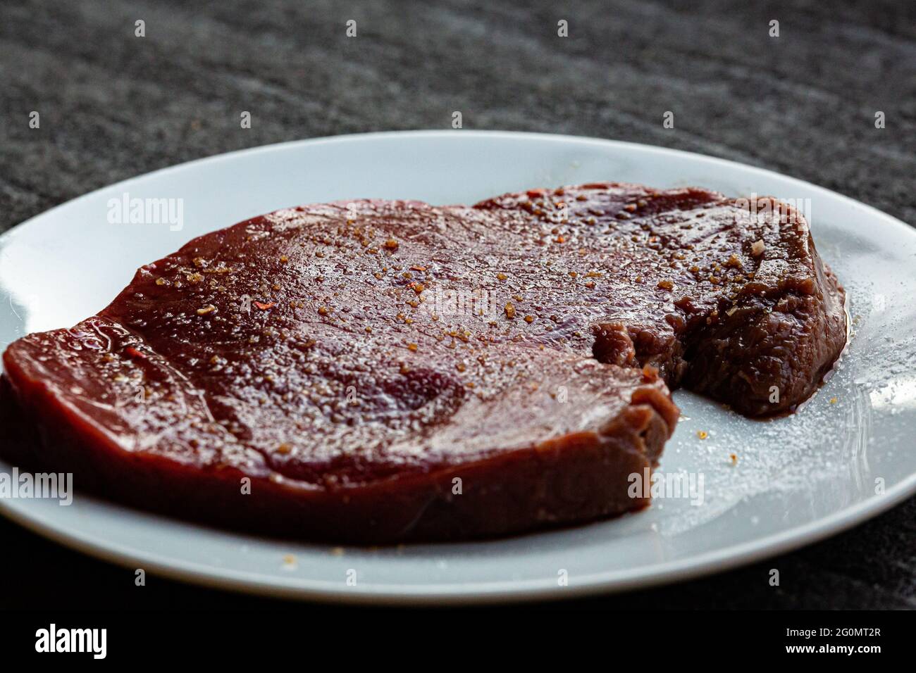 Raw meat being seasoned hi-res stock photography and images - Alamy