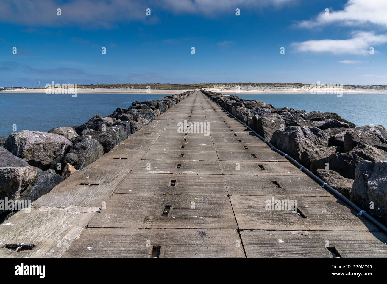 View of long rocky and concrete storm groin jetty to protect against ...