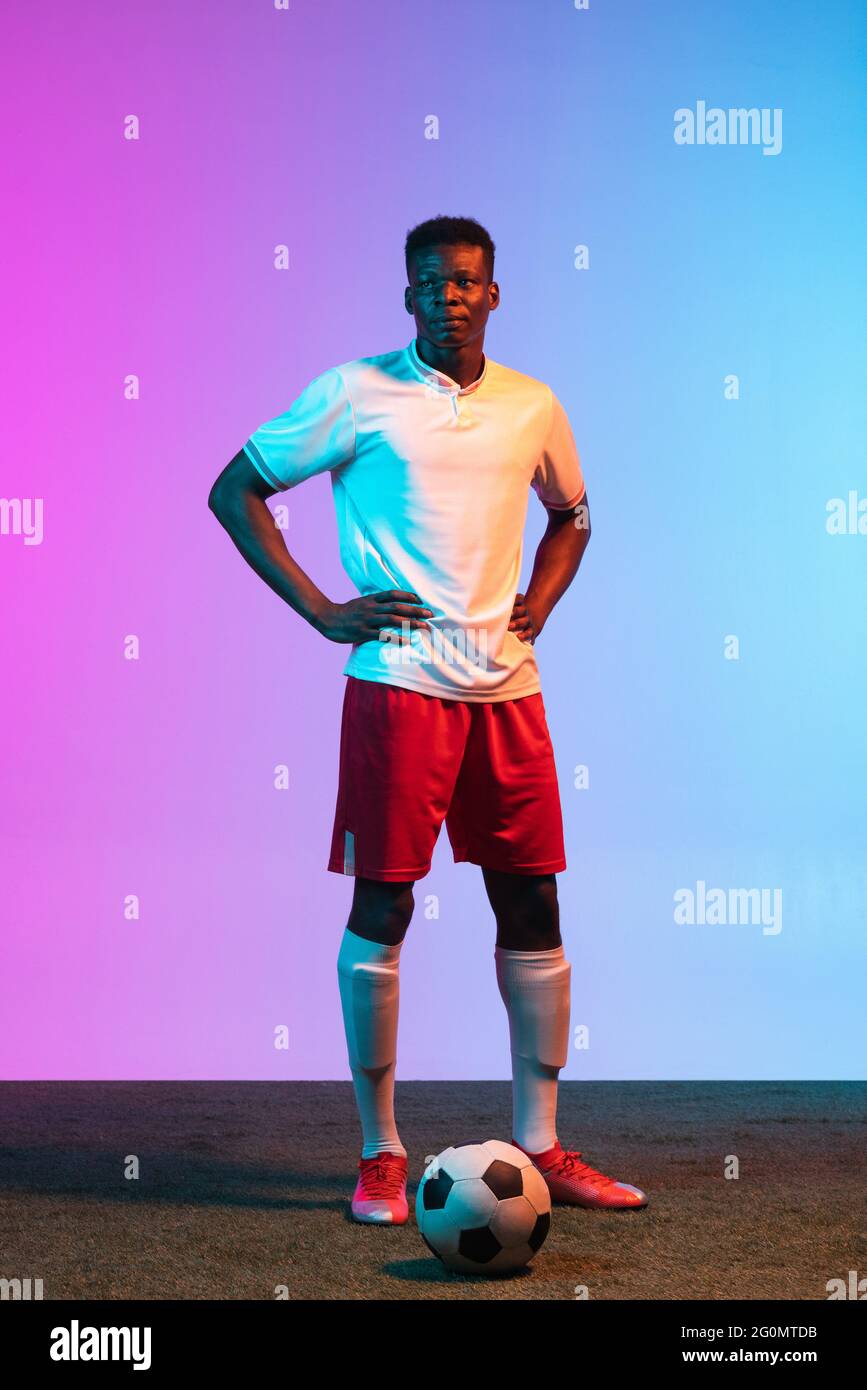 Full -length portrait of African professional football player standing ...