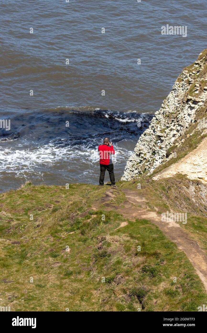 Person on edge of chalk cliff hi-res stock photography and images - Alamy
