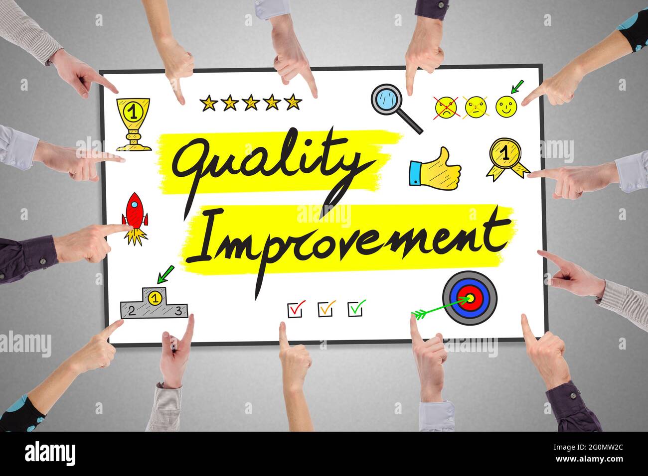 Hands pointing to quality improvement concept Stock Photo - Alamy