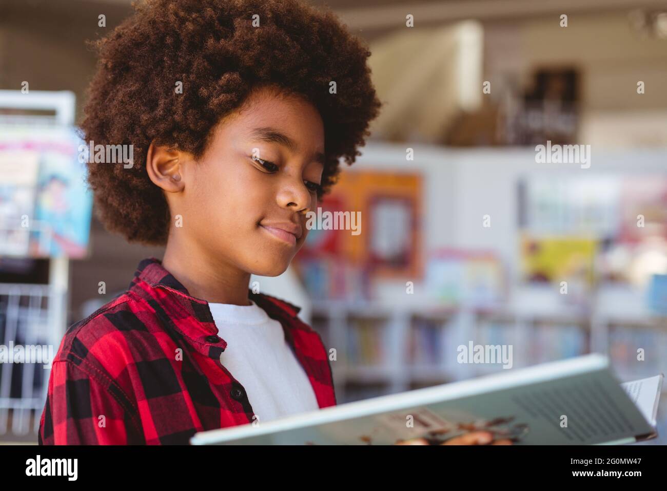 African schoolboy reading book hi-res stock photography and images - Alamy