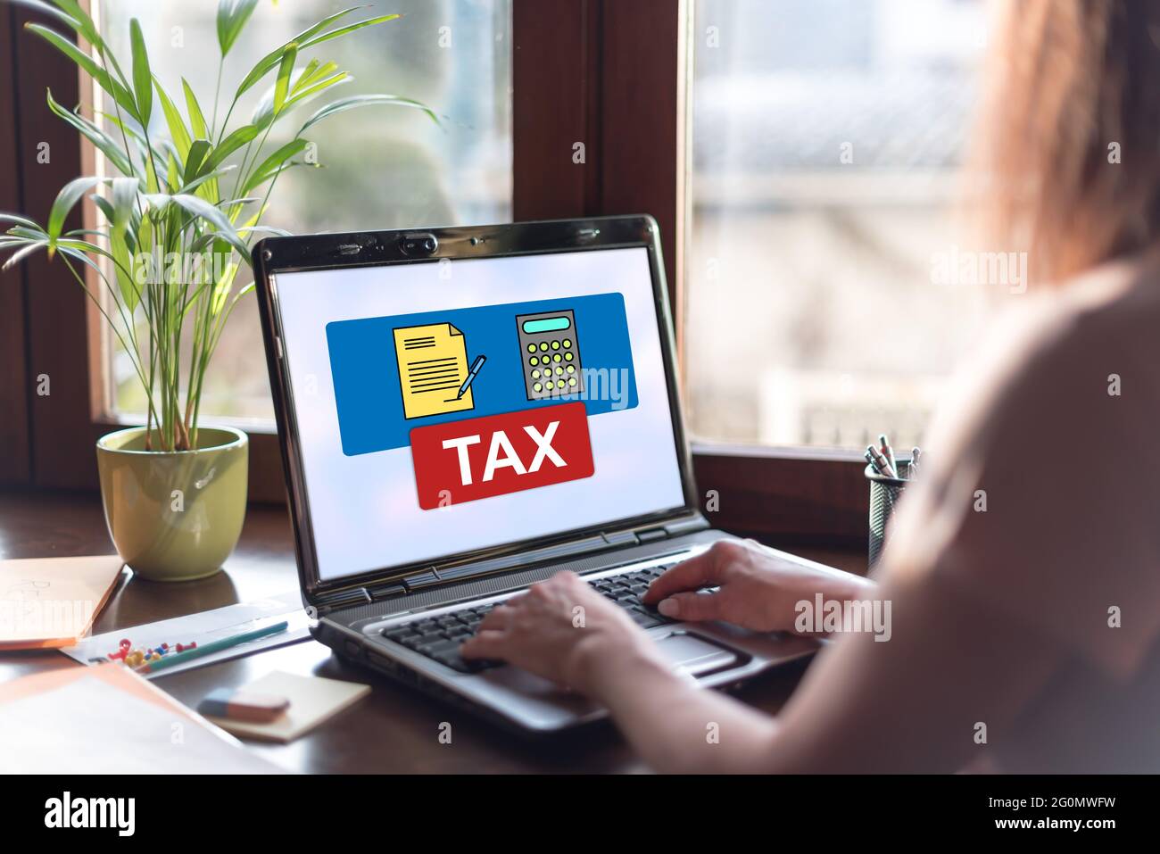 Laptop screen displaying a tax concept Stock Photo - Alamy