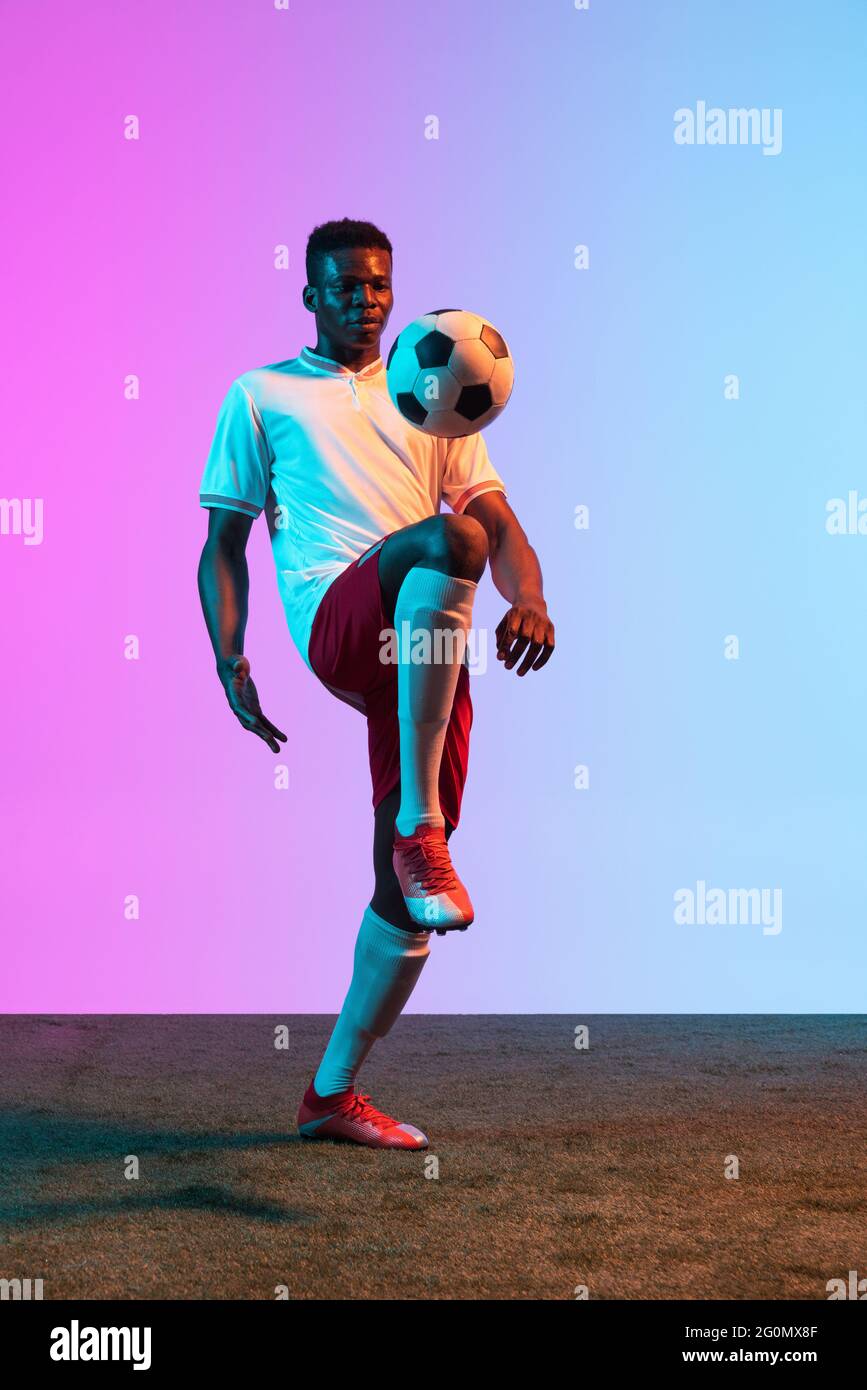 One African man, professional soccer football player training isolated ...
