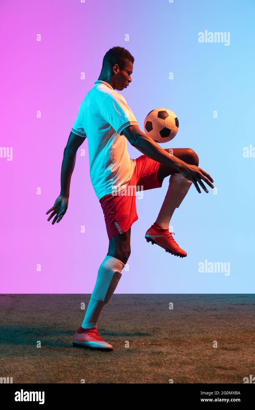 One African man, professional soccer football player training isolated ...