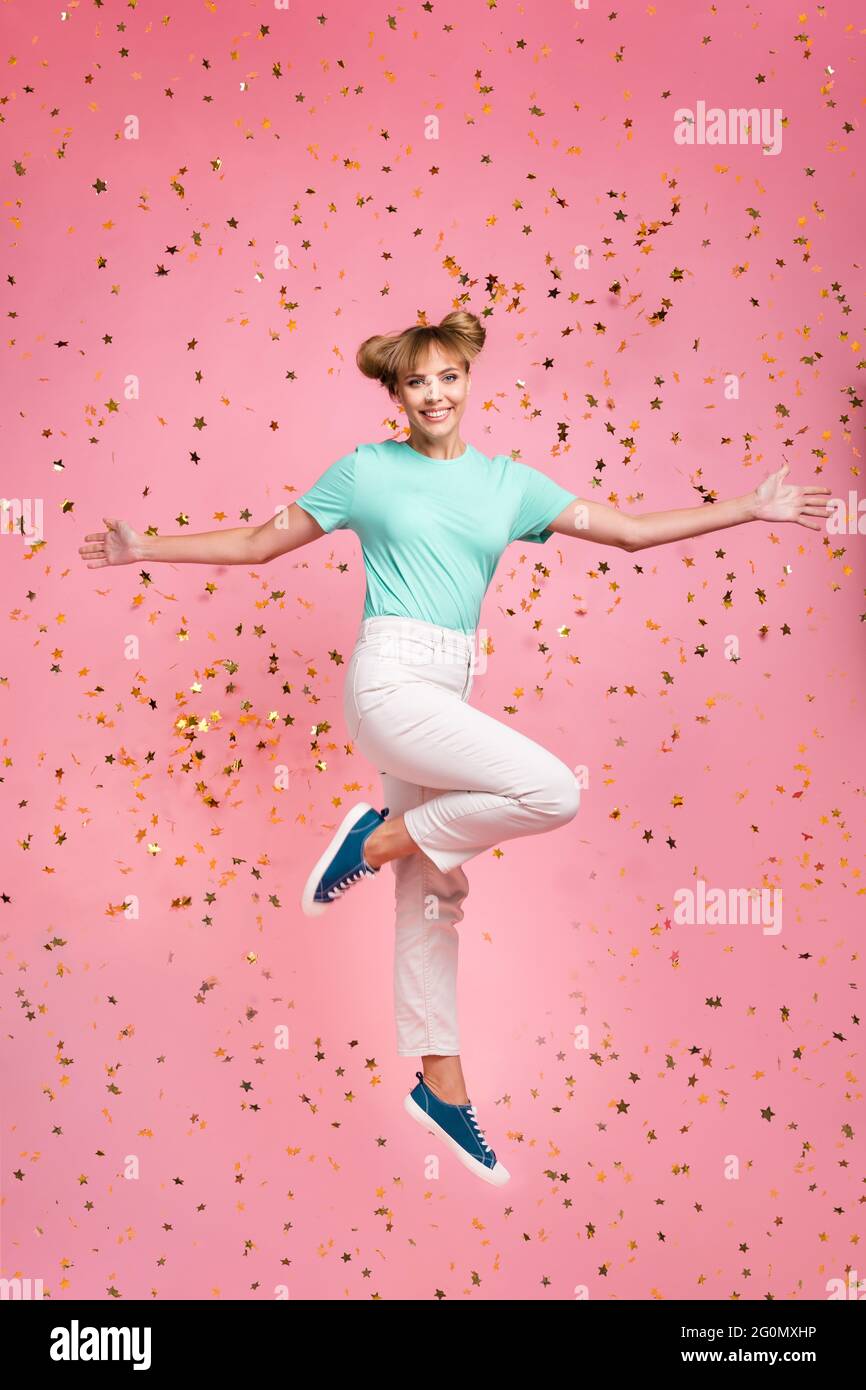 Full body vertical portrait of pretty cheerful lady jump hands sides ...