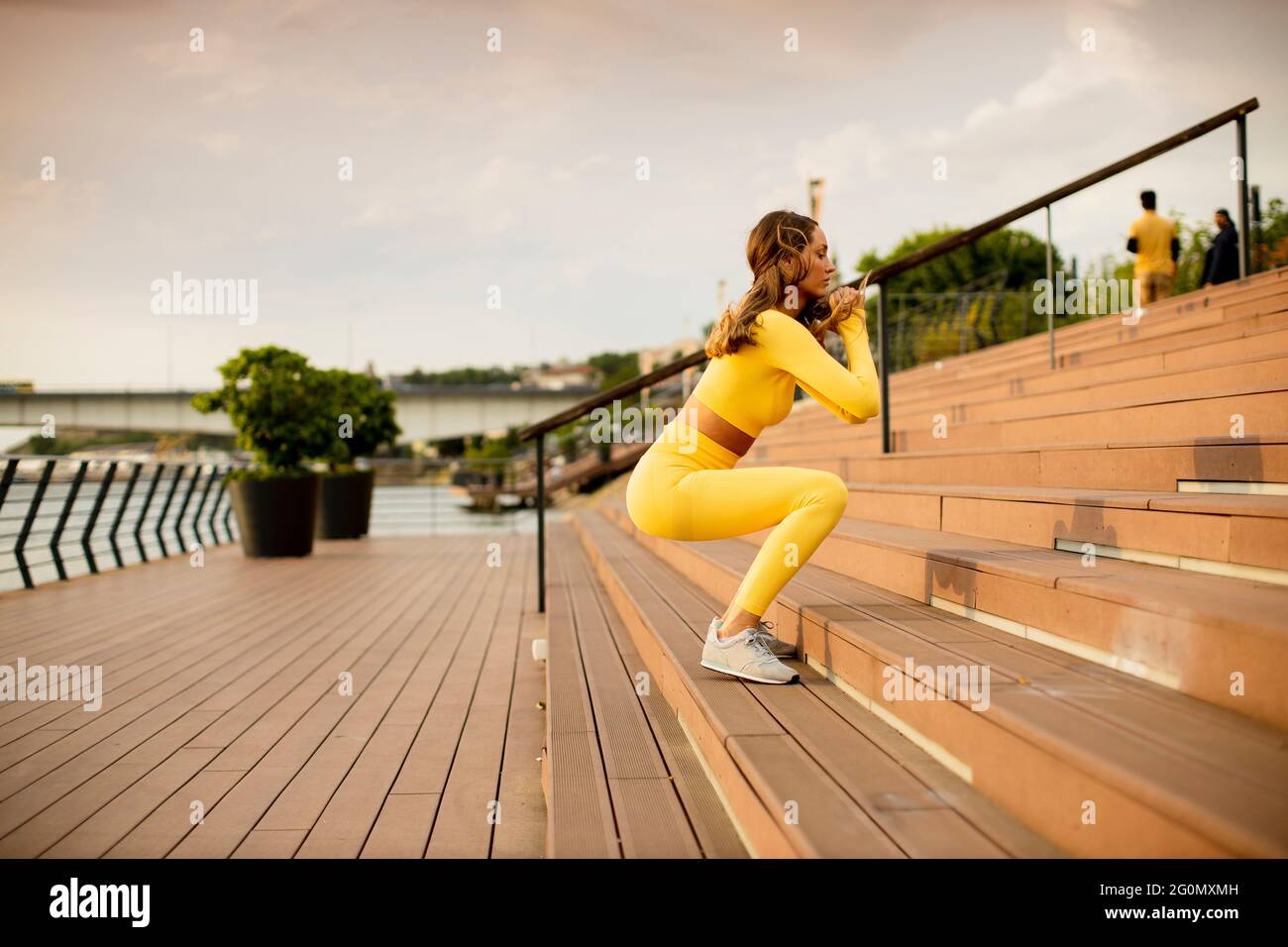 Beautiful young woman jumping on the stairs at the riverside Stock ...