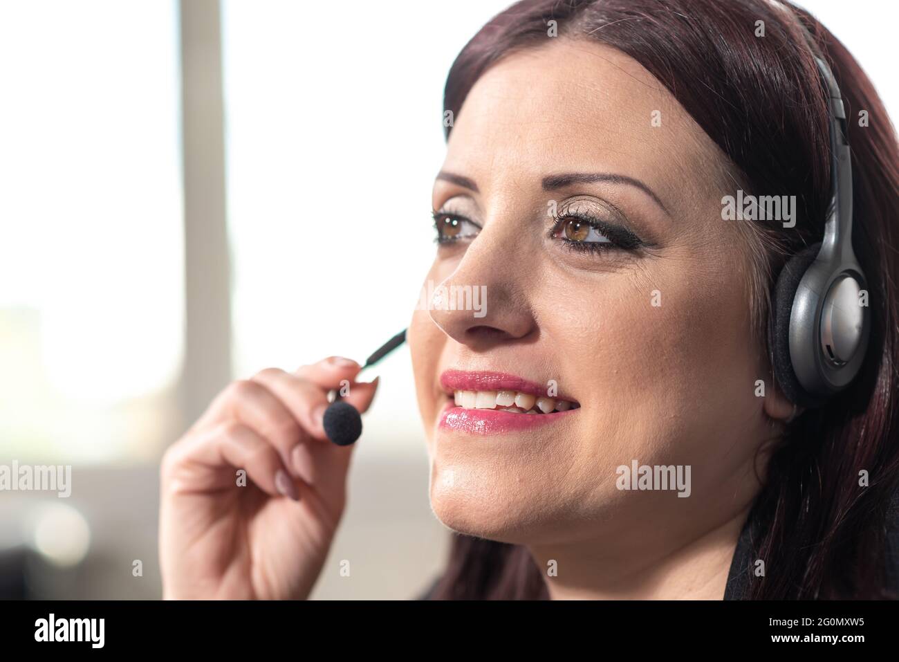Portrait of smiling female phone operator with headset Stock Photo - Alamy