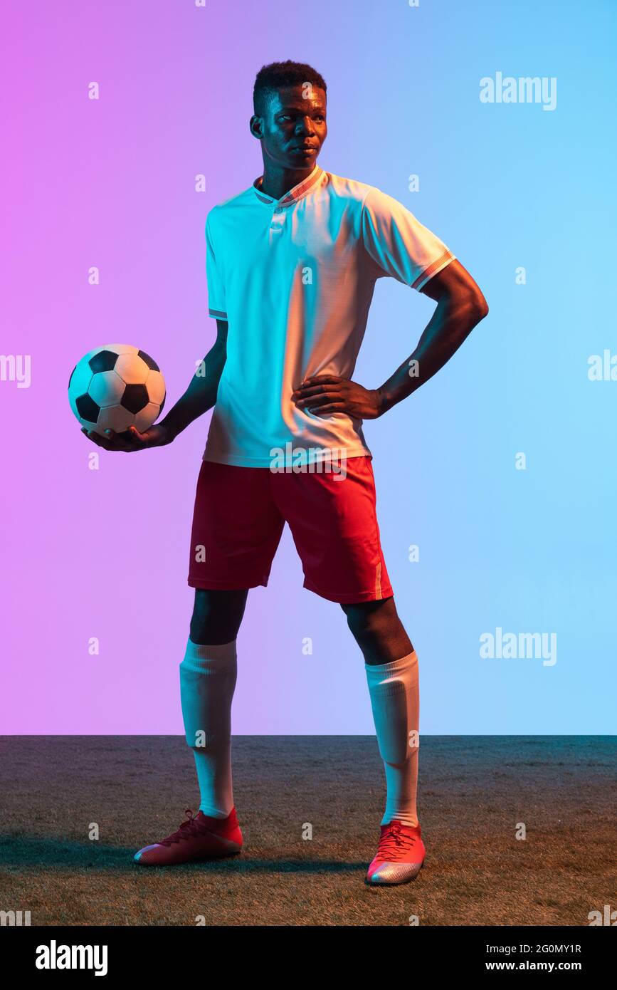 Full -length portrait of African professional football player standing ...