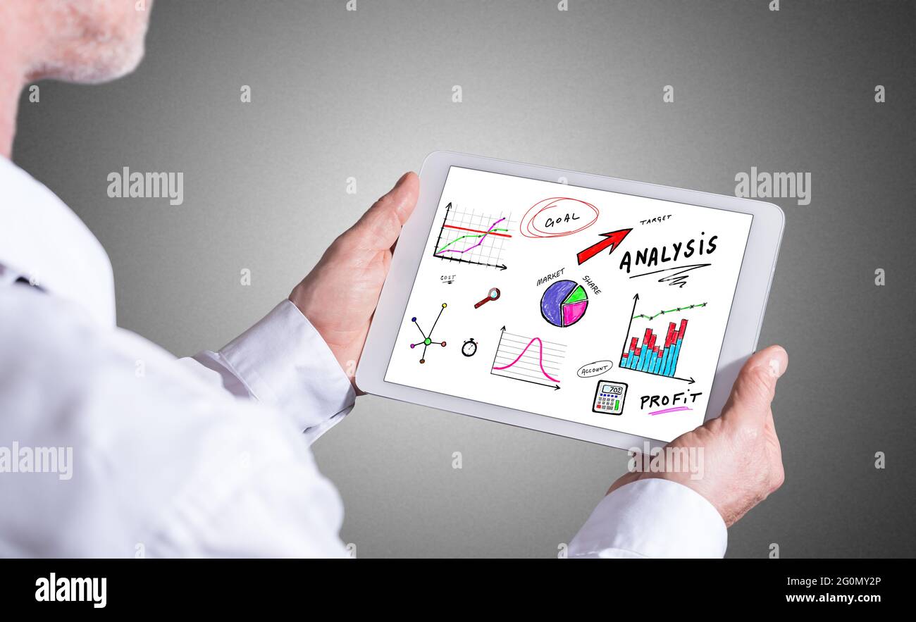Man holding a tablet showing analysis concept Stock Photo - Alamy