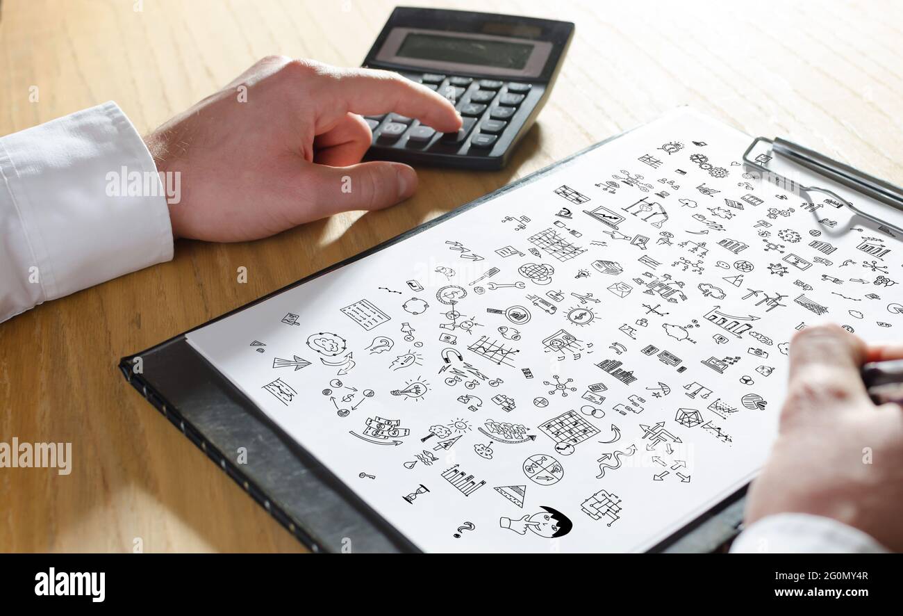 Creativity concept with hand using a calculator Stock Photo - Alamy