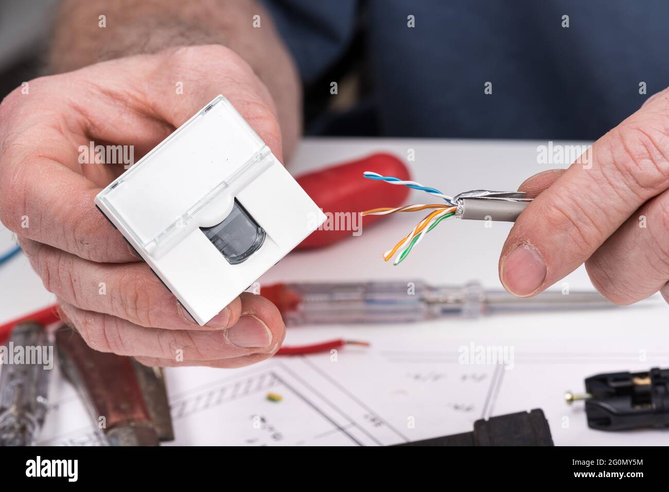 Hand holding an ethernet outlet and a cable Stock Photo - Alamy