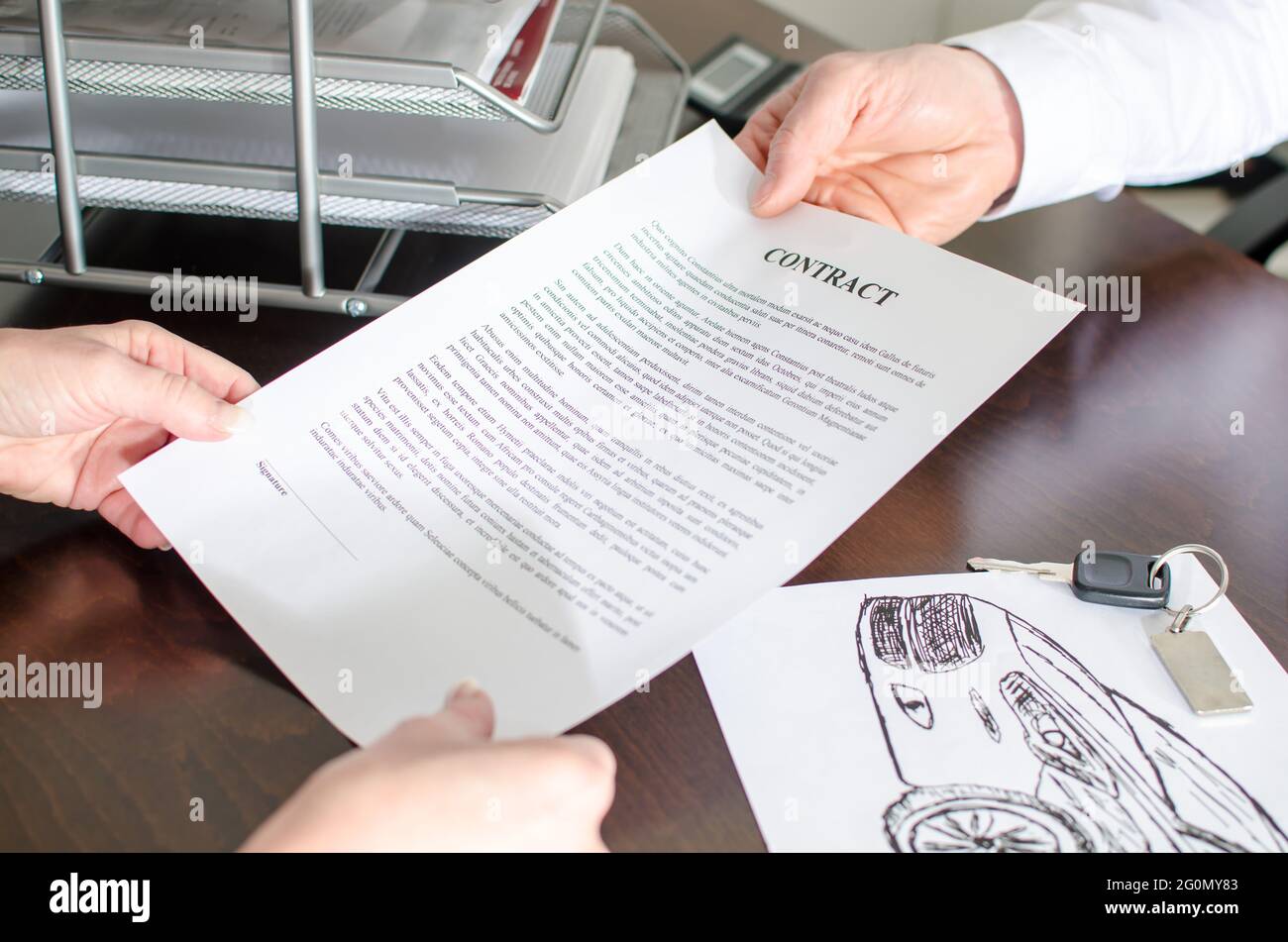 Dealer showing a car purchase contract in car dealership Stock Photo ...