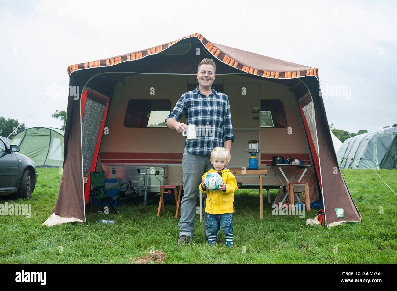 Standing outside a caravan / camper at a festival in a field Stock ...