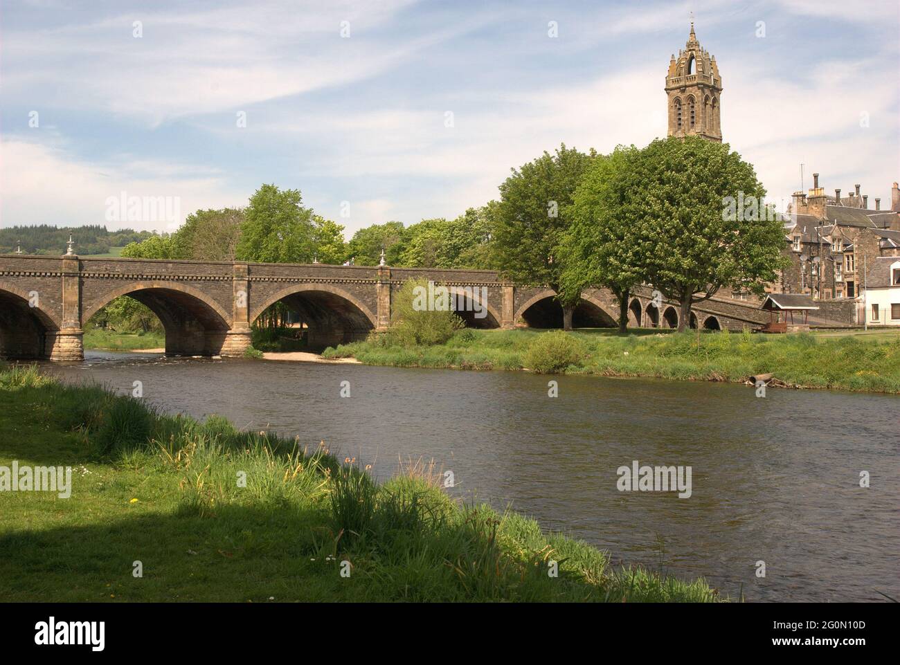 arched bridge over river Tweed and church tower at Peebles in summer ...