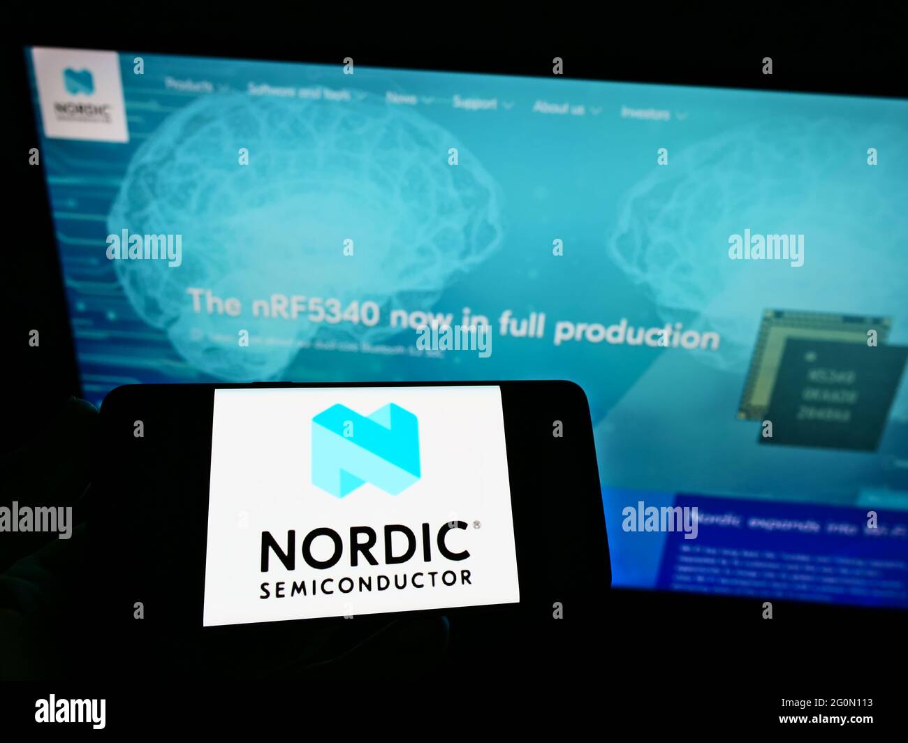 Person holding cellphone with logo of Norwegian company Nordic ...
