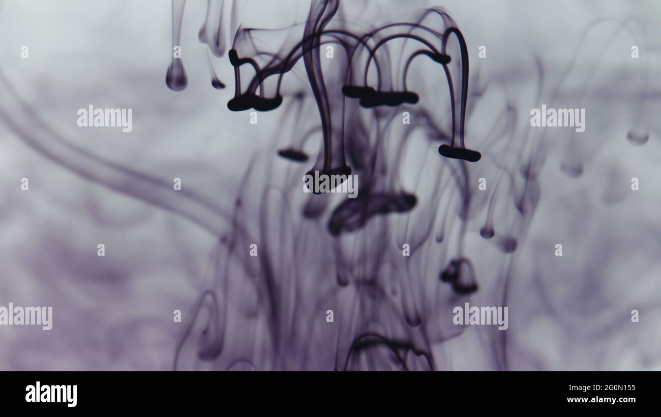 Photo of drops of purple paint falling in water Stock Photo - Alamy