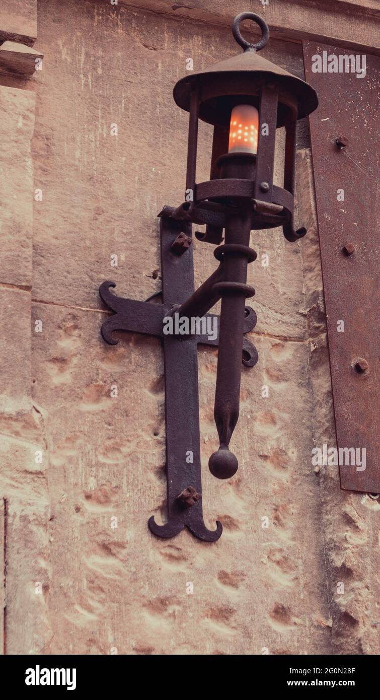 replica of an ancient medieval lantern on a solid stone wall Stock ...