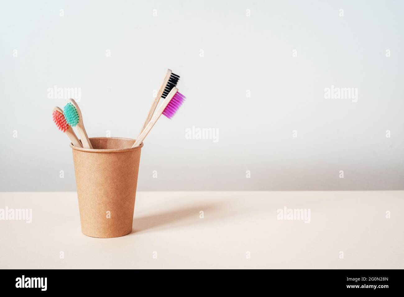 Multicolored eco friendly bamboo toothbrushes in paper cup, dental care ...