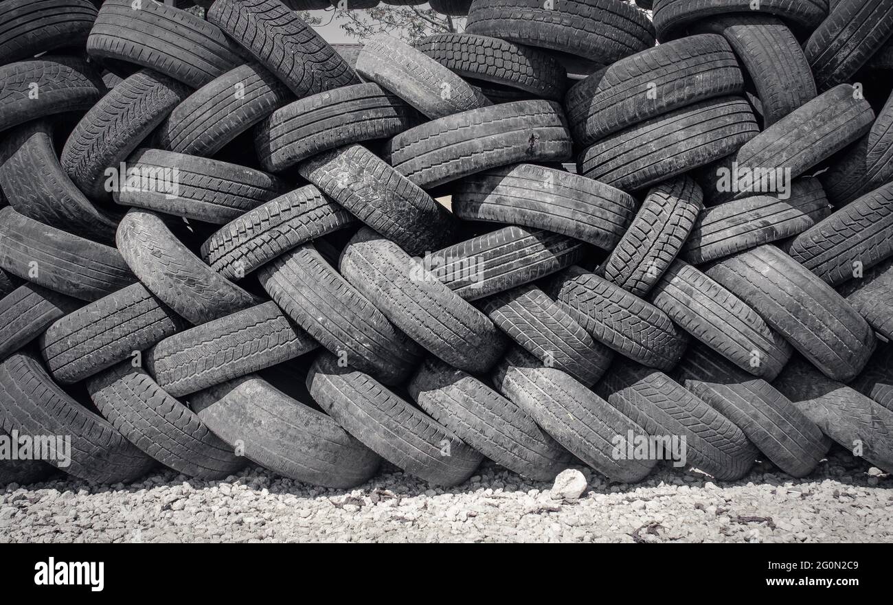 Car tires are stacked in large piles at car repair shop Stock Photo - Alamy