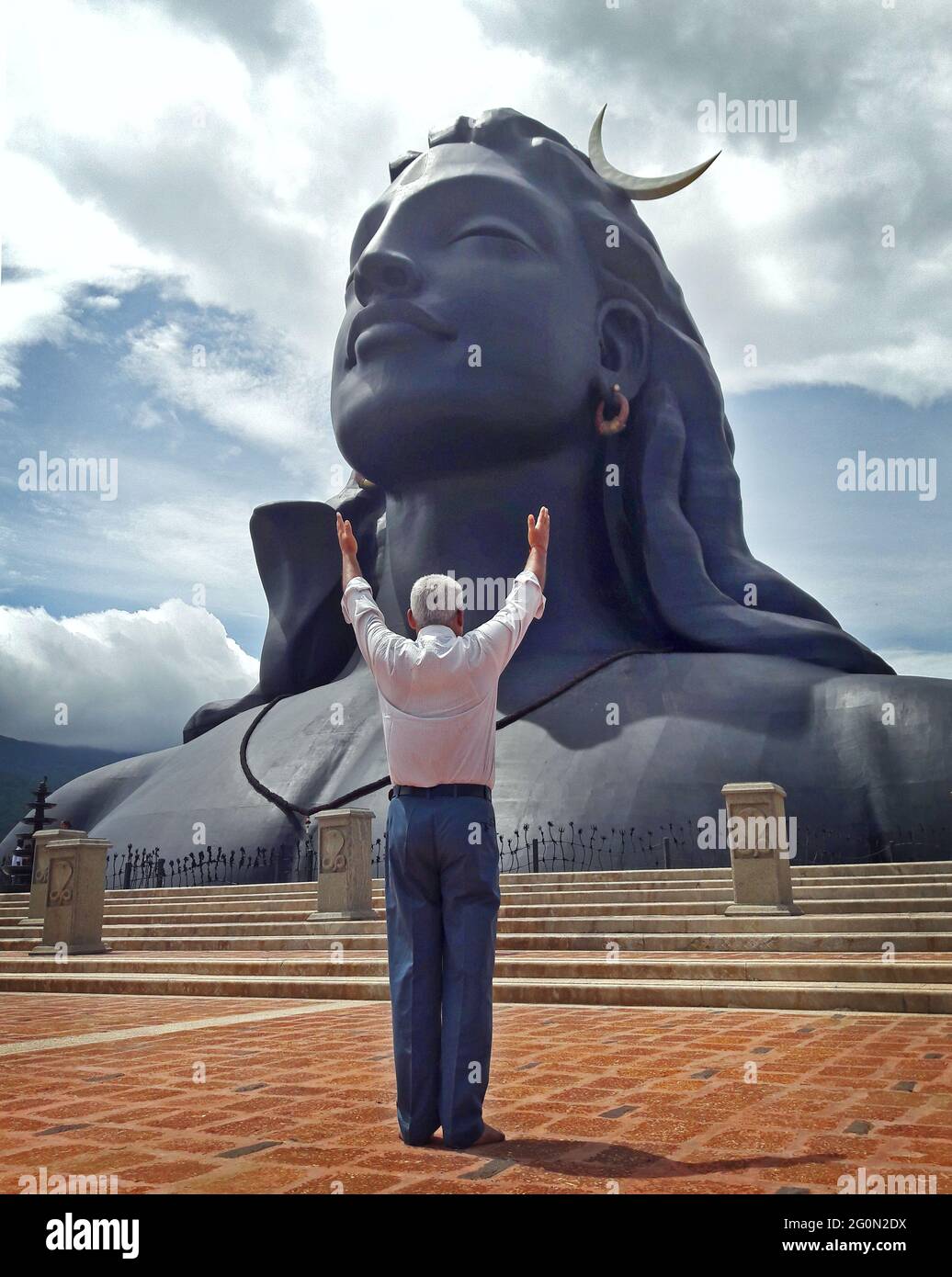 Devotee paying salutaion to the adiyogi shiva in yog asnam image is ...