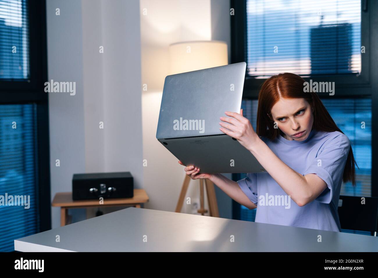 Frustrated young woman confused by laptop computer problem sitting at ...
