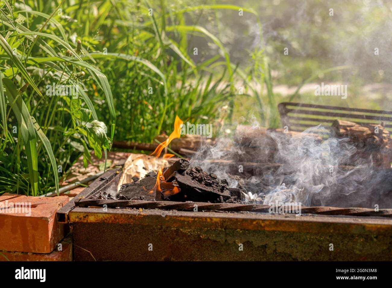 barbecue grill with fire and smoke. backyard outdoors Stock Photo - Alamy