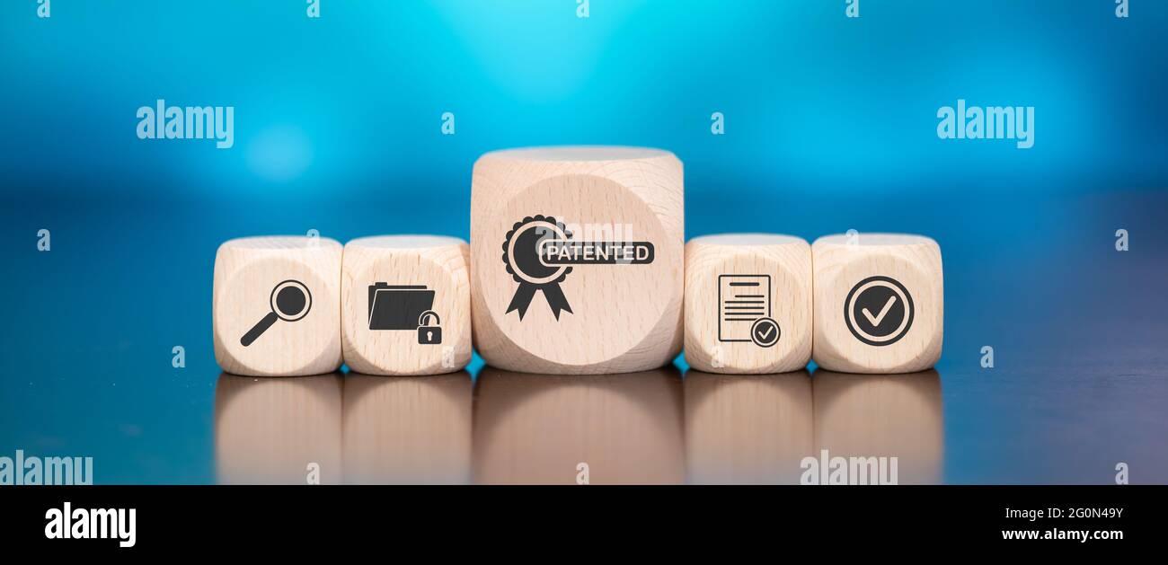 Wooden blocks with symbol of patent concept on blue background Stock ...