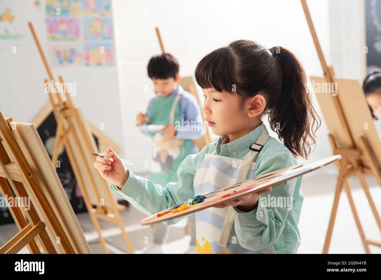 Children learning to paint Stock Photo - Alamy
